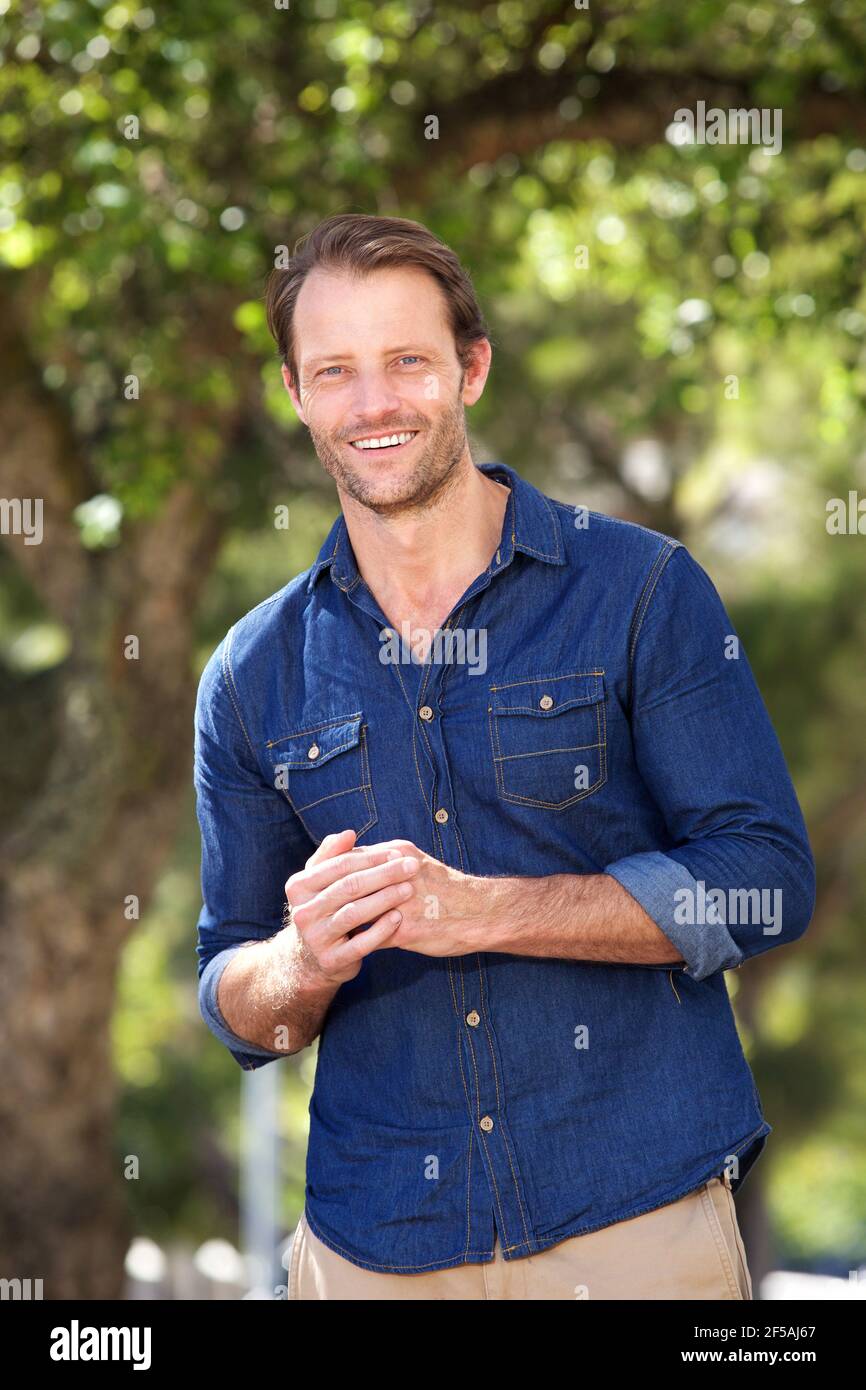 Portrait of cool older guy smiling outside Stock Photo - Alamy