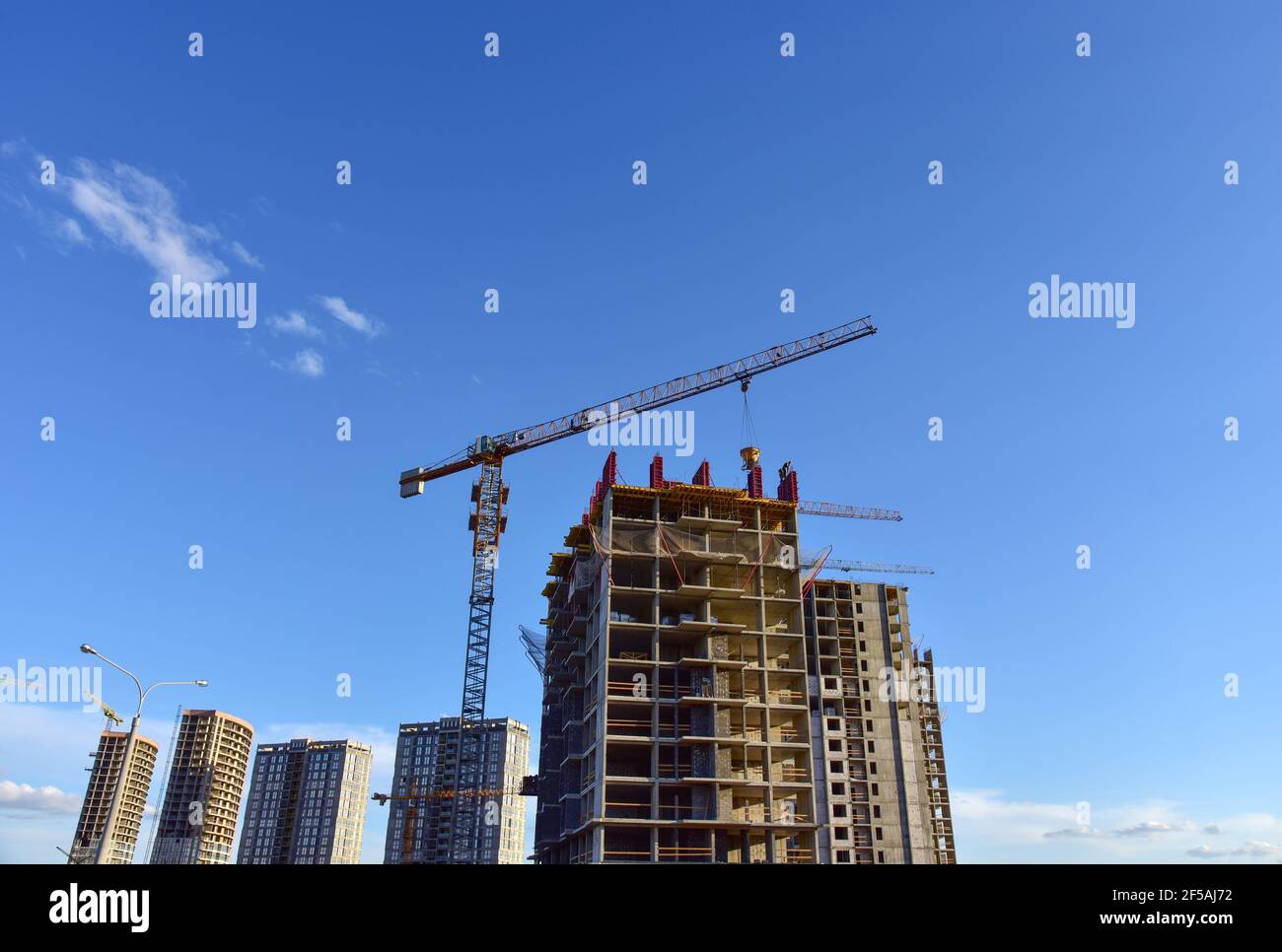 Preparing to pour a bucket of concrete into formwork.Tower crane ...