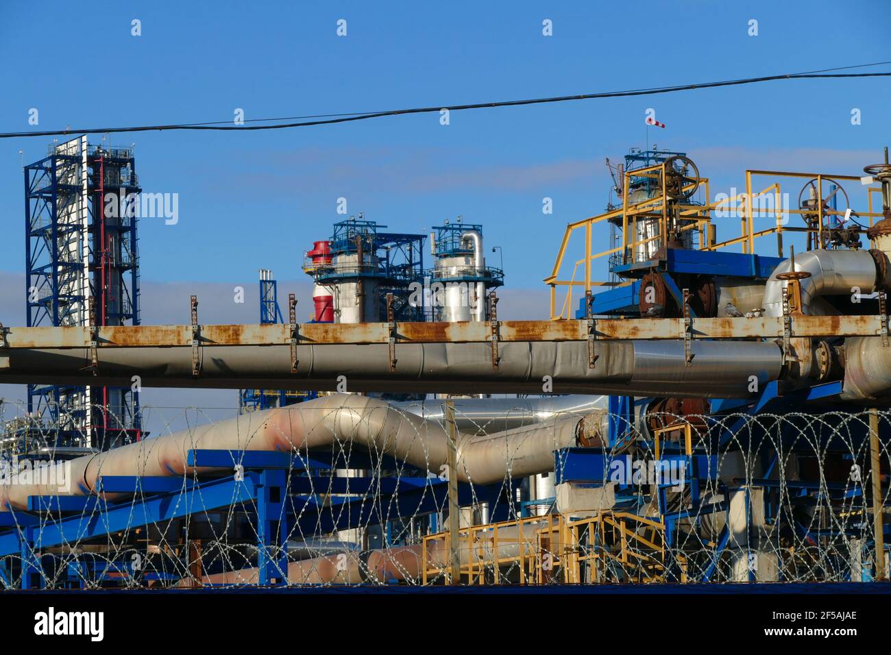 Corps of Moscow refinery in spring in clear weather 2021 Stock Photo ...