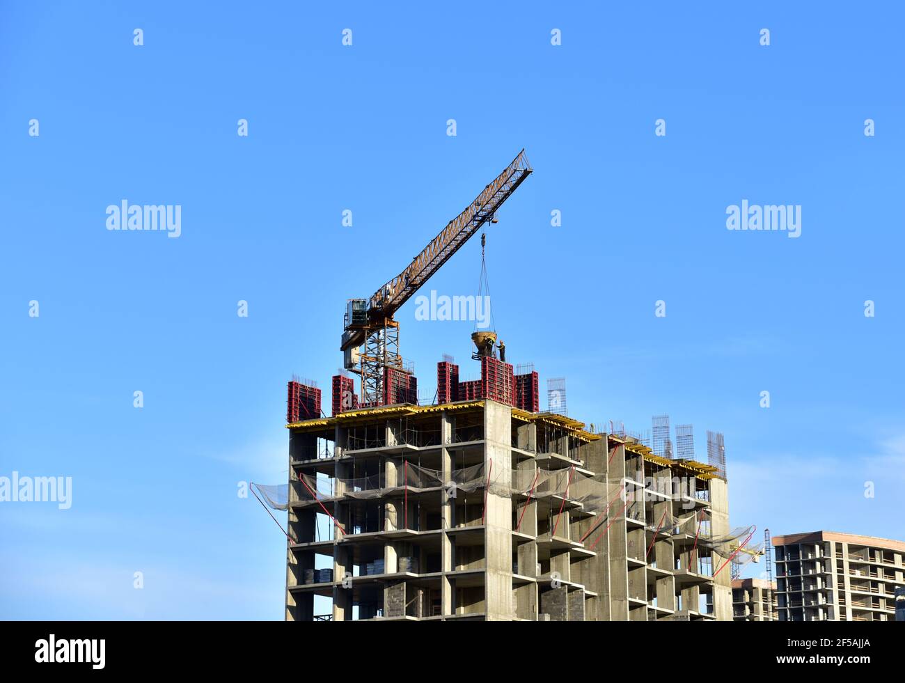 Preparing to pour a bucket of concrete into formwork.Tower crane ...