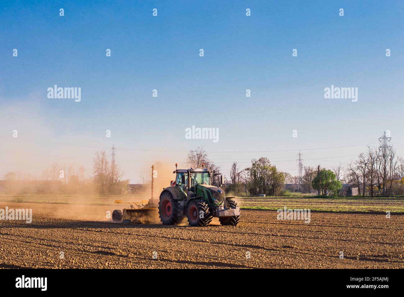 Tractor working in the field, preparing the land for planting Stock ...
