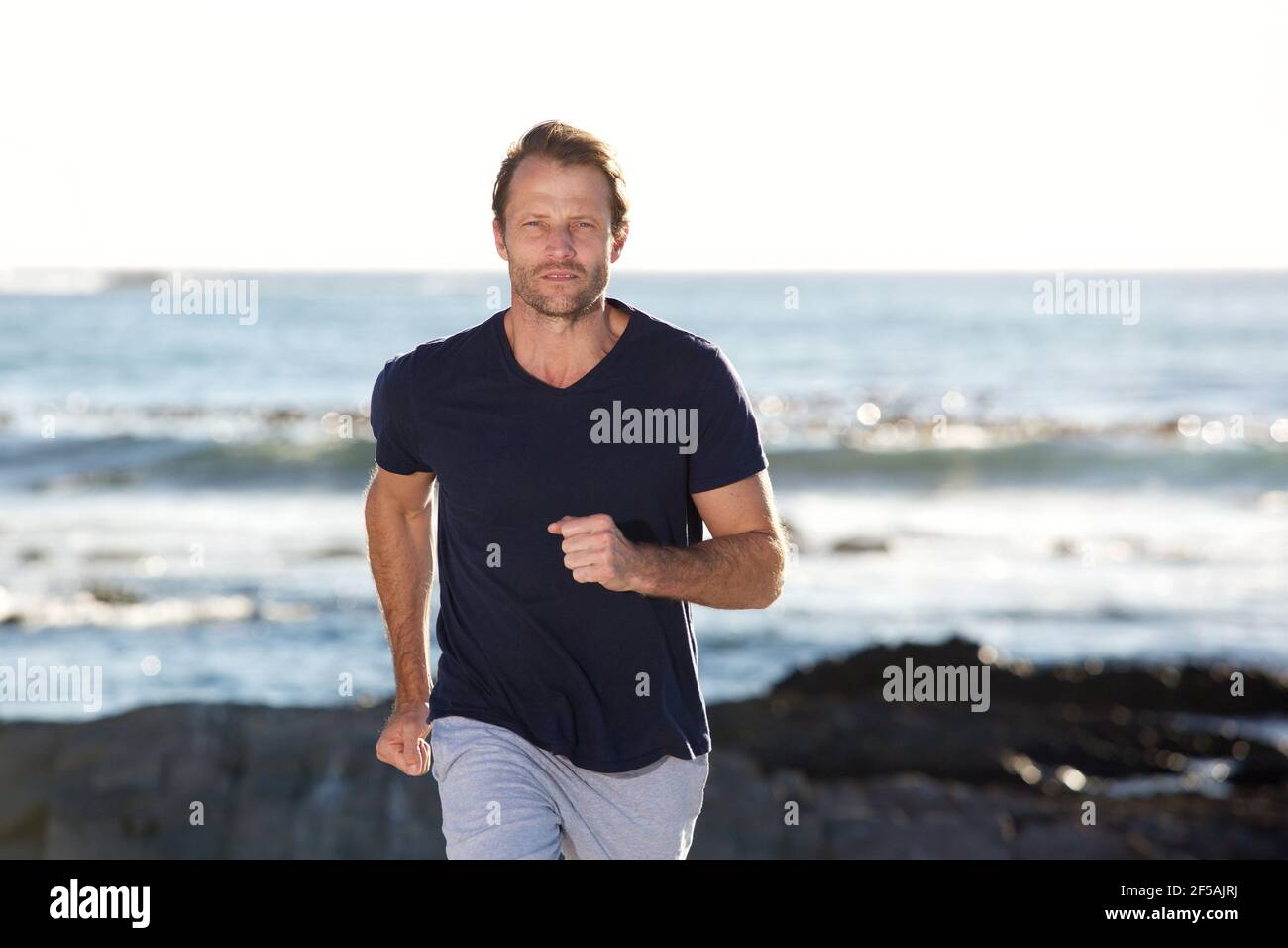 Handsome man running hi-res stock photography and images - Alamy