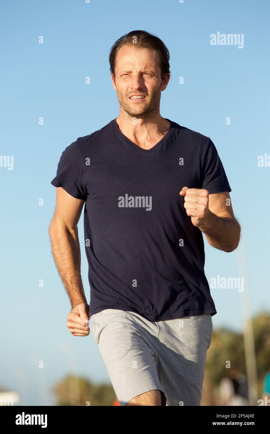 Portrait of healthy active man running outside Stock Photo - Alamy