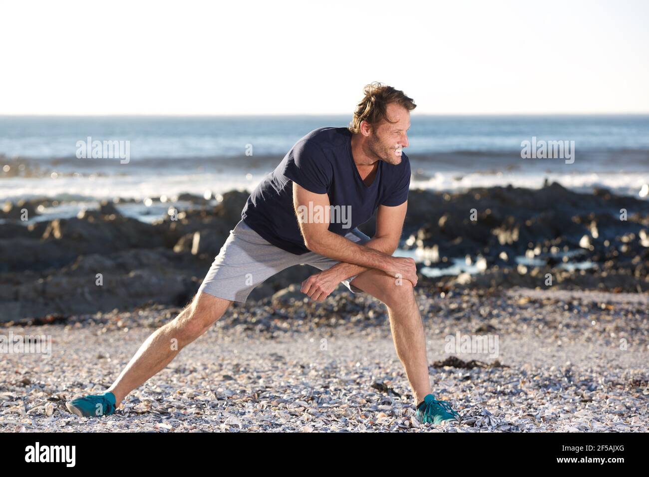Full length portrait of sports man stretching outside Stock Photo - Alamy