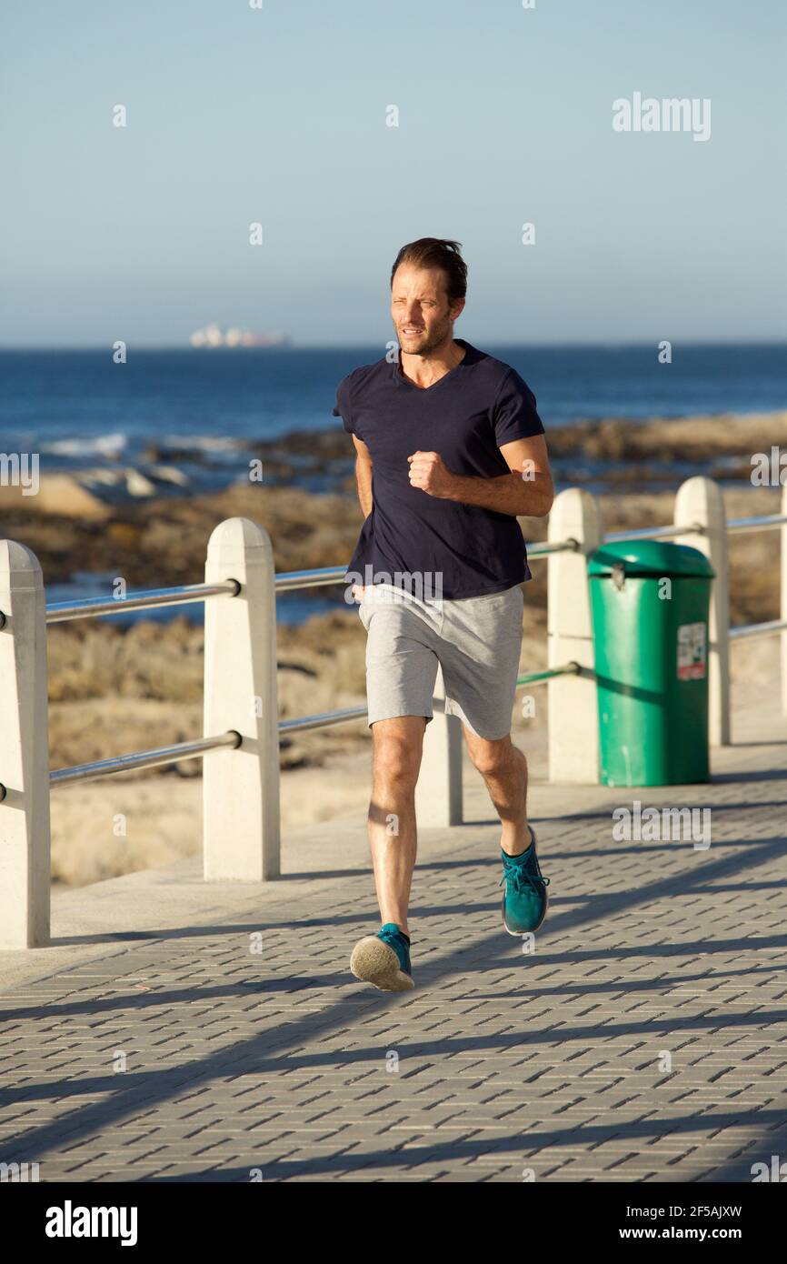 Full body portrait of healthy sports man running outside Stock Photo ...