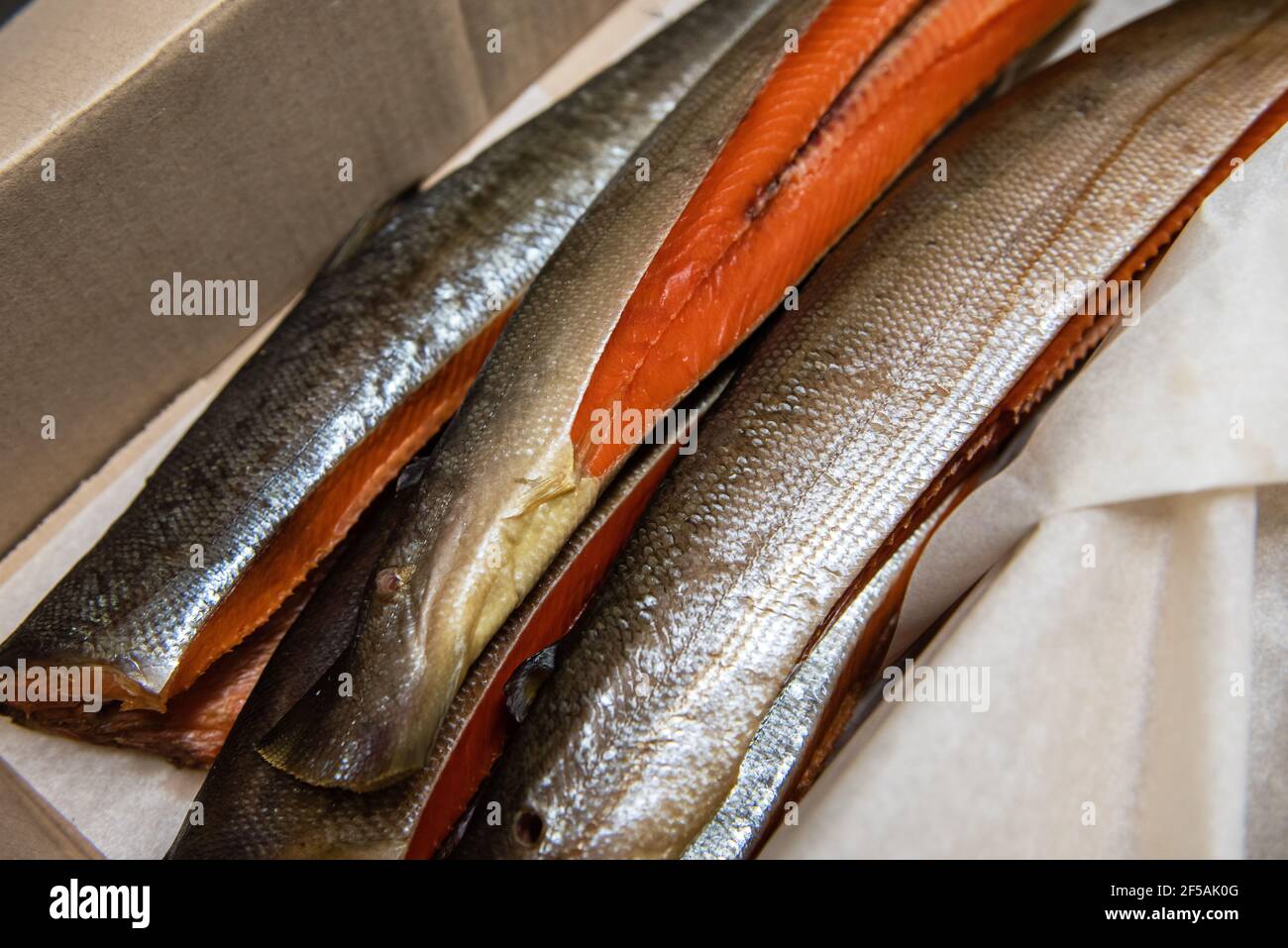 Smoked fish in craft paper box. Ready for delivery production. Smoked ...