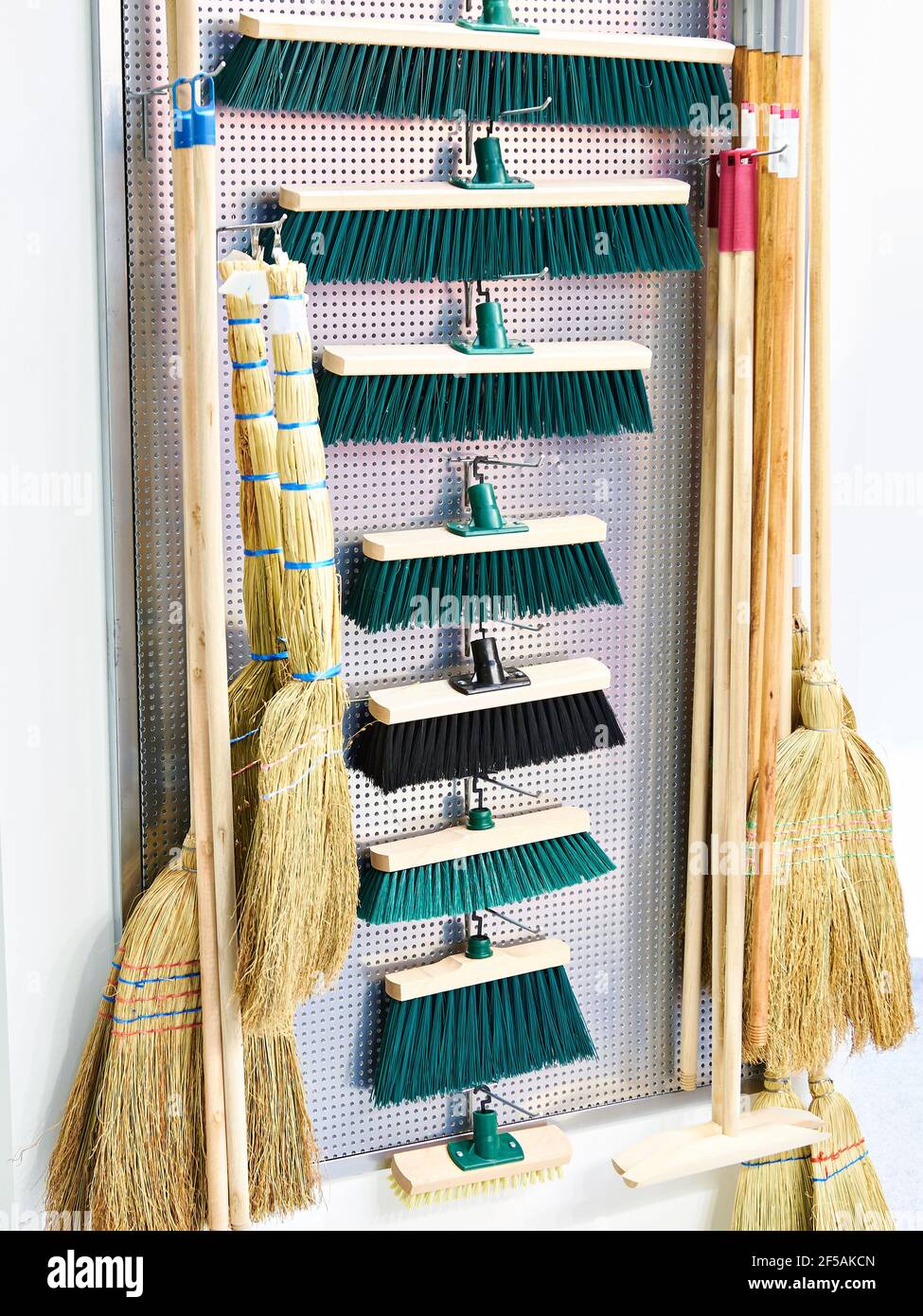 Brushes and brooms in the household goods store Stock Photo - Alamy