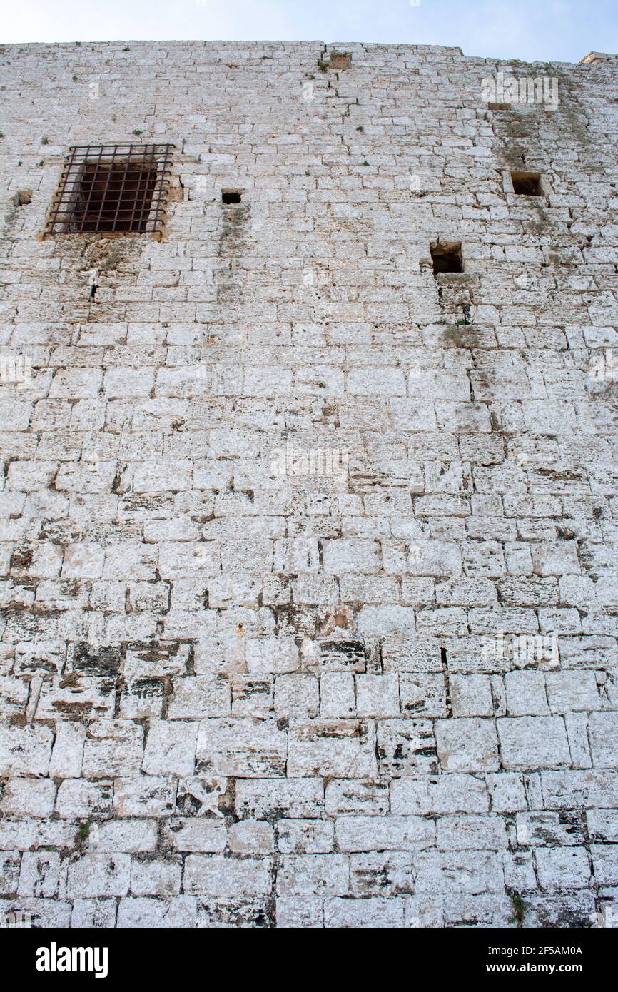 Vertical shot of a white brick wall with small windows Stock Photo - Alamy