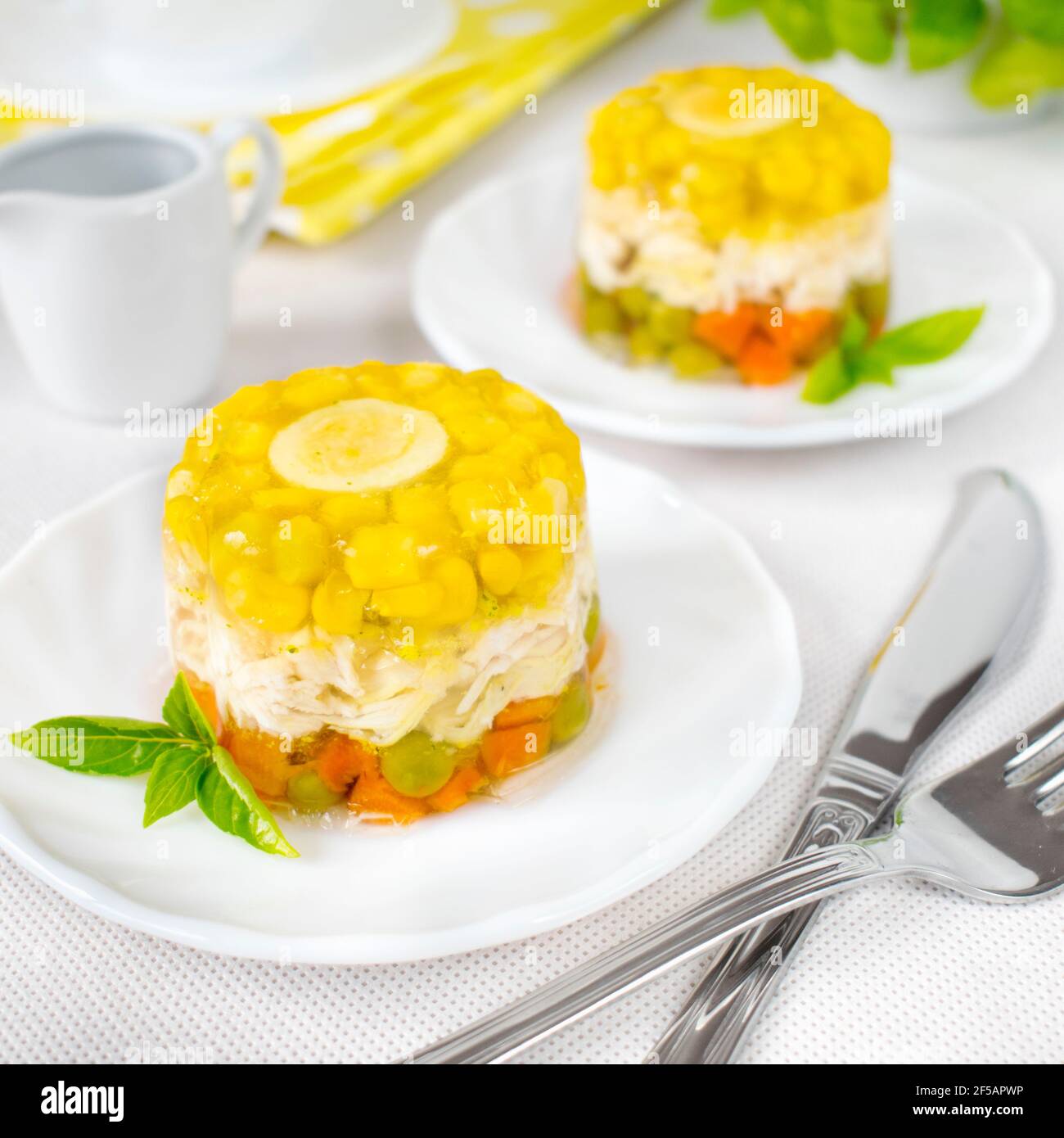 Layered chicken jelly with carrots and corn Stock Photo - Alamy