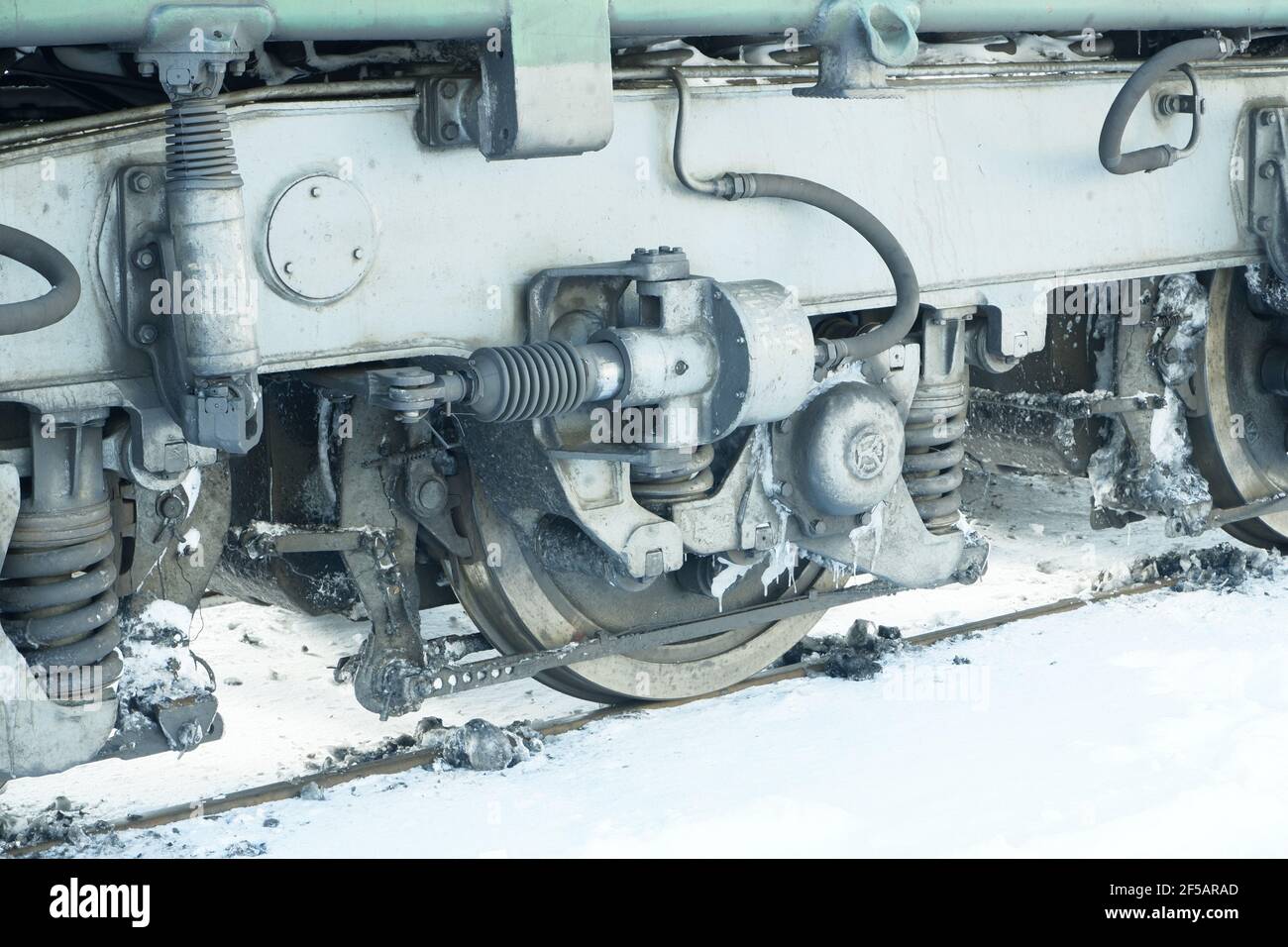 The wheel assembly of an electric locomotive of a train standing on ...