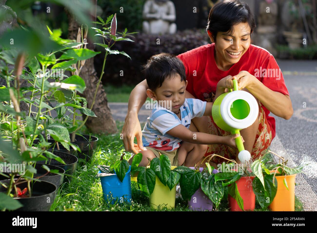 BALI/INDONESIA-SEPT 5 2020: The son and his mother are spending time ...