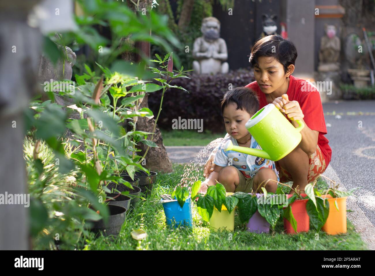 BALI/INDONESIA-SEPT 5 2020: The son and his mother are spending time ...