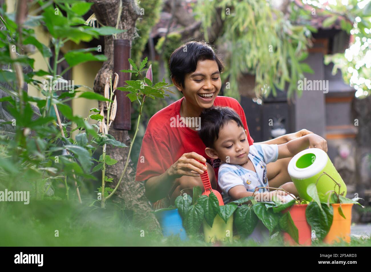 BALI/INDONESIA-SEPT 5 2020: The son and his mother are spending time ...