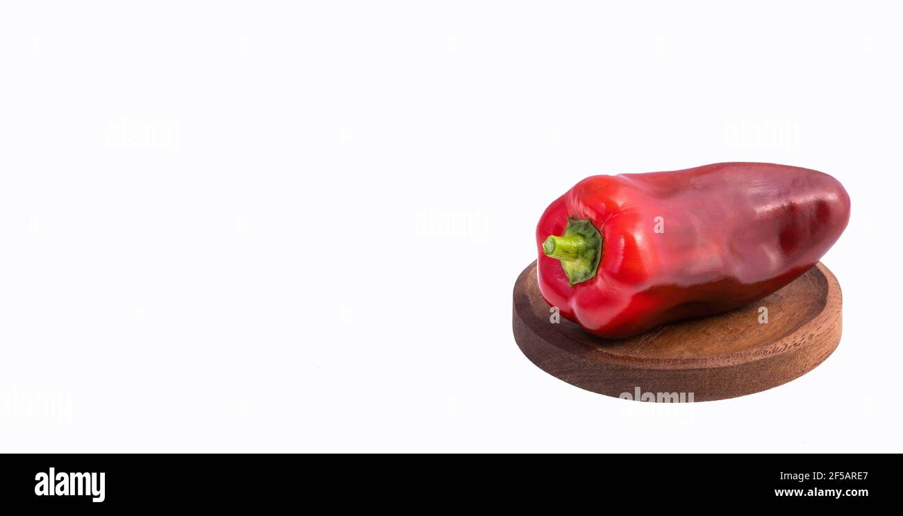 Organic fresh bell pepper on wooden plate - Capsicum annuum Stock Photo ...