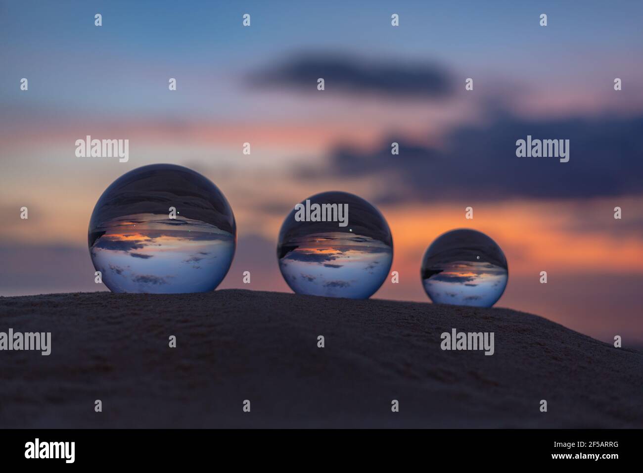 Three clear crystal balls of three sizes are sphere reveals seascape ...