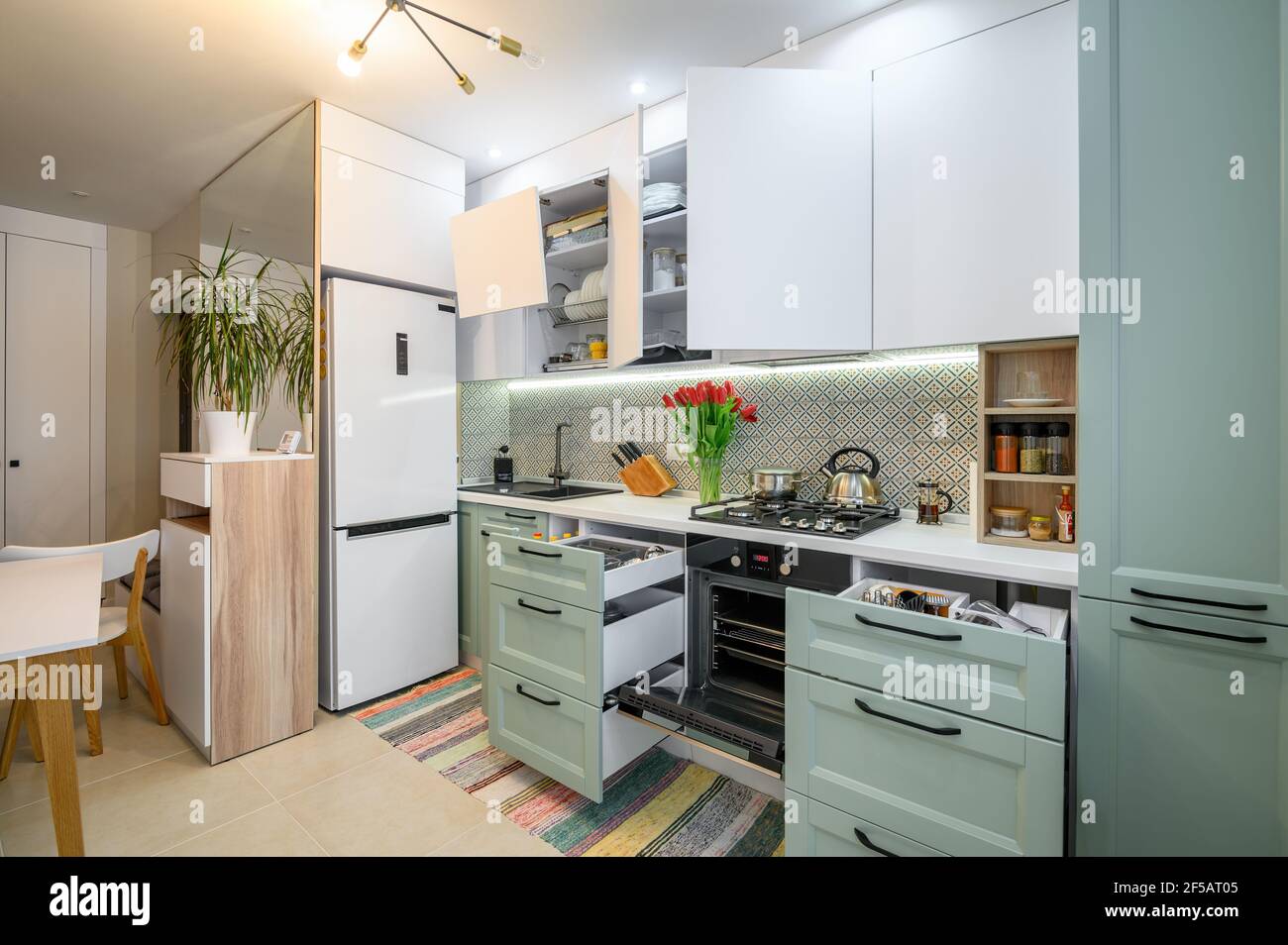 Cozy modern kitchen interior, some drawers pulled out Stock Photo - Alamy