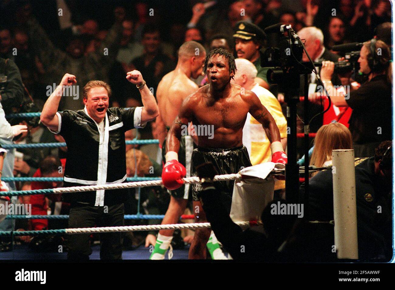 Nigel Benn turns to the crowd in triumph after beaten Gerald McClellan ...