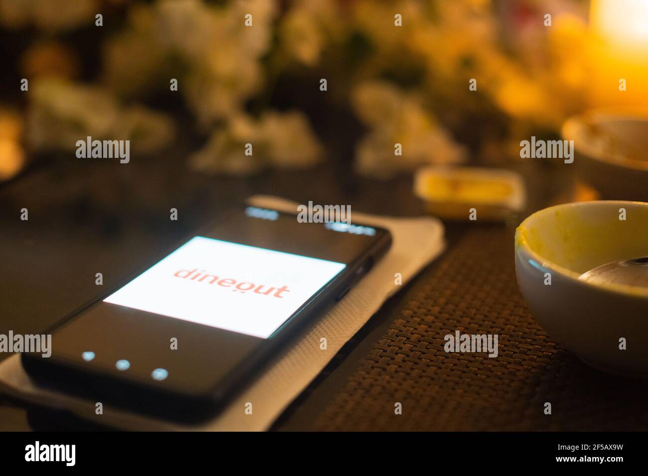 mobile phone with the foodtech app startup dineout open offering ...