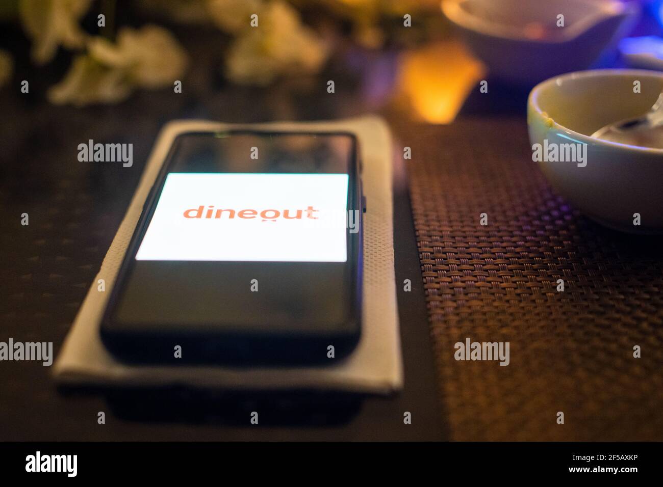 mobile phone with the foodtech app startup dineout open offering ...