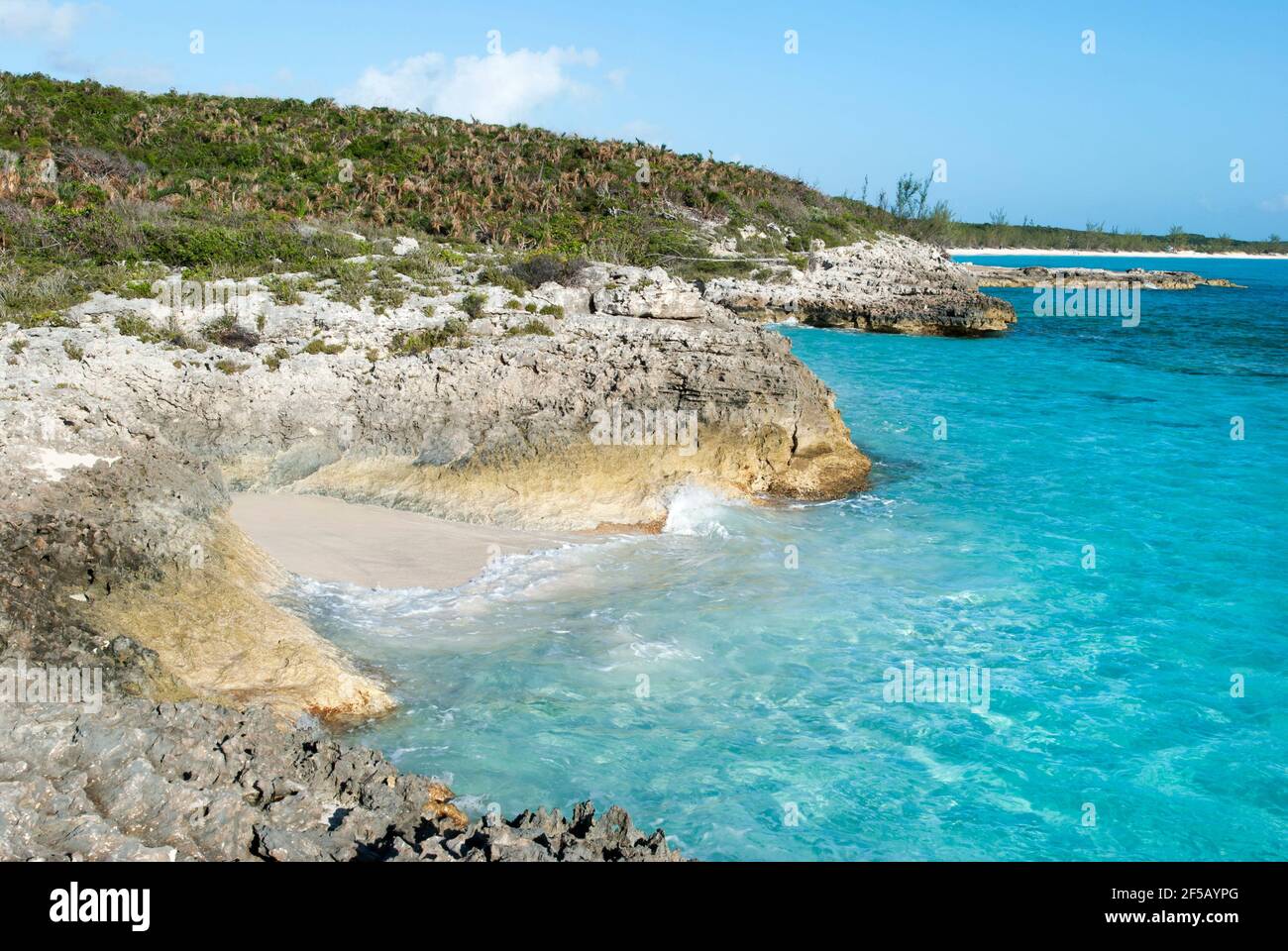 The scenic view of Half Moon Cay uninhabited island rocky coastline and ...