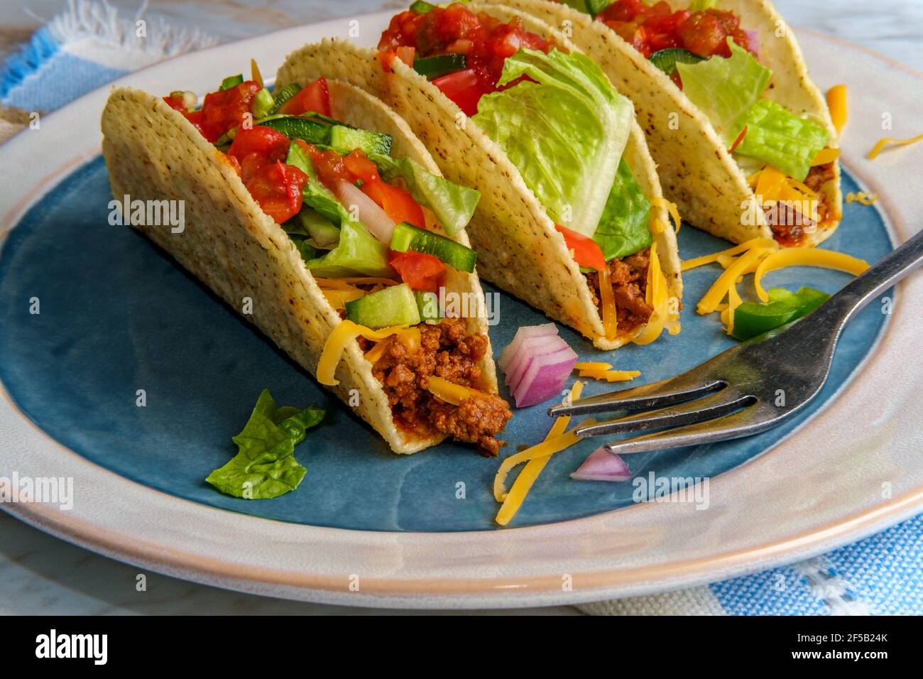 Mexican beef tacos with romaine lettuce cheddar cheese red onions and ...