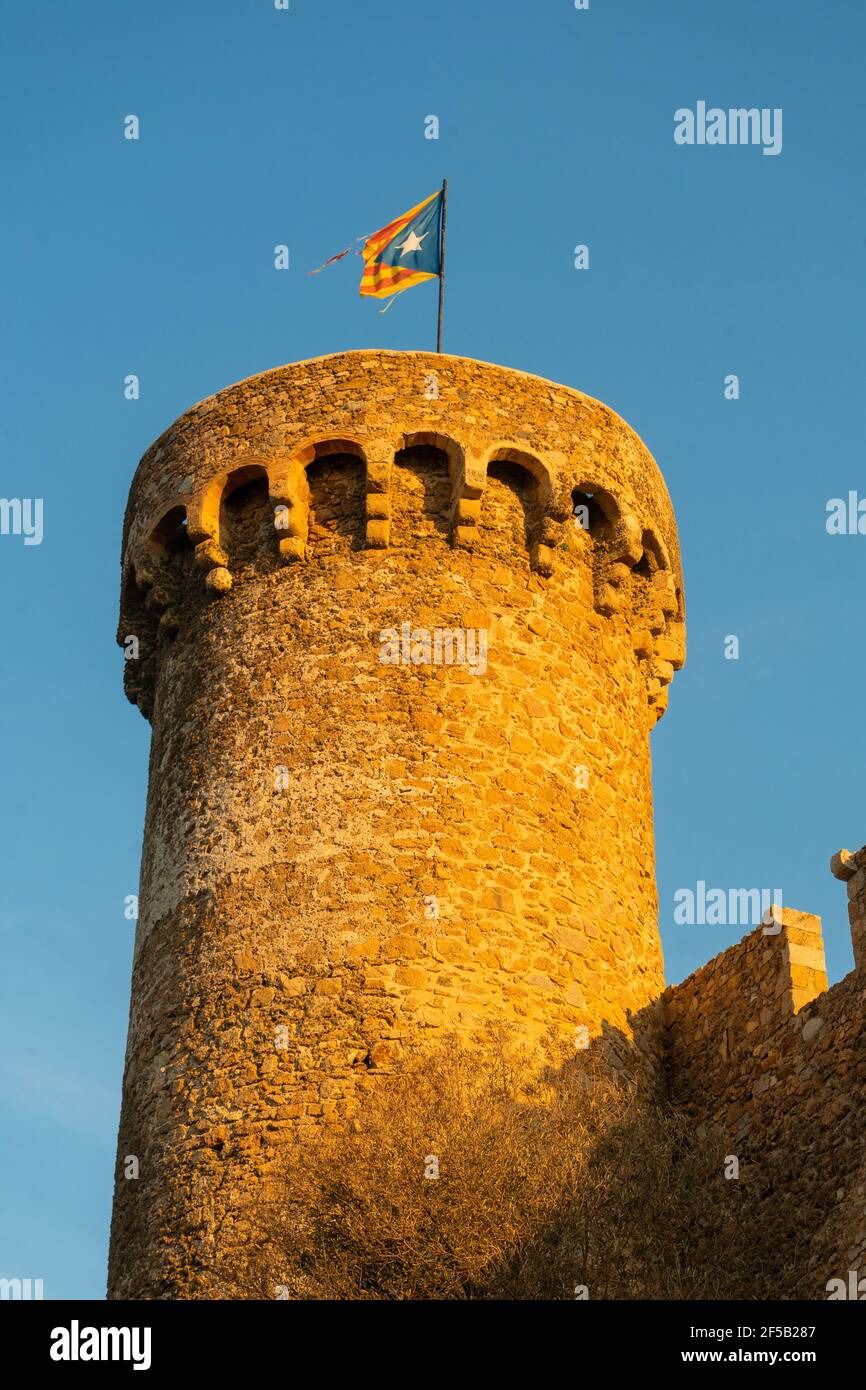 The tower of castle with Catalan flag at beach of Tossa de Mar and ...