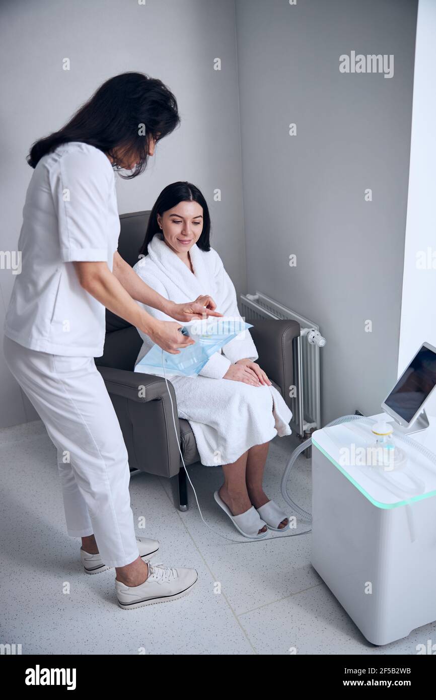 Physician telling about a medical procedure to a smiling patient Stock ...