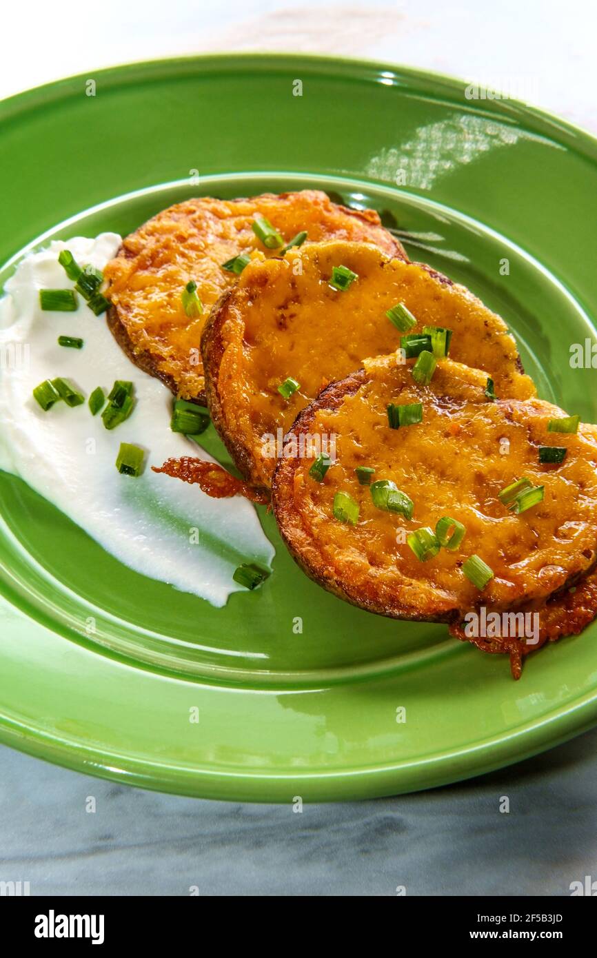 Cheesy oven roasted cheddar potato rounds with sour cream and chive ...