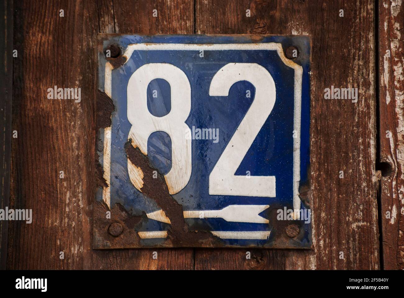 Weathered grunge square metal enamelled plate of number of street ...