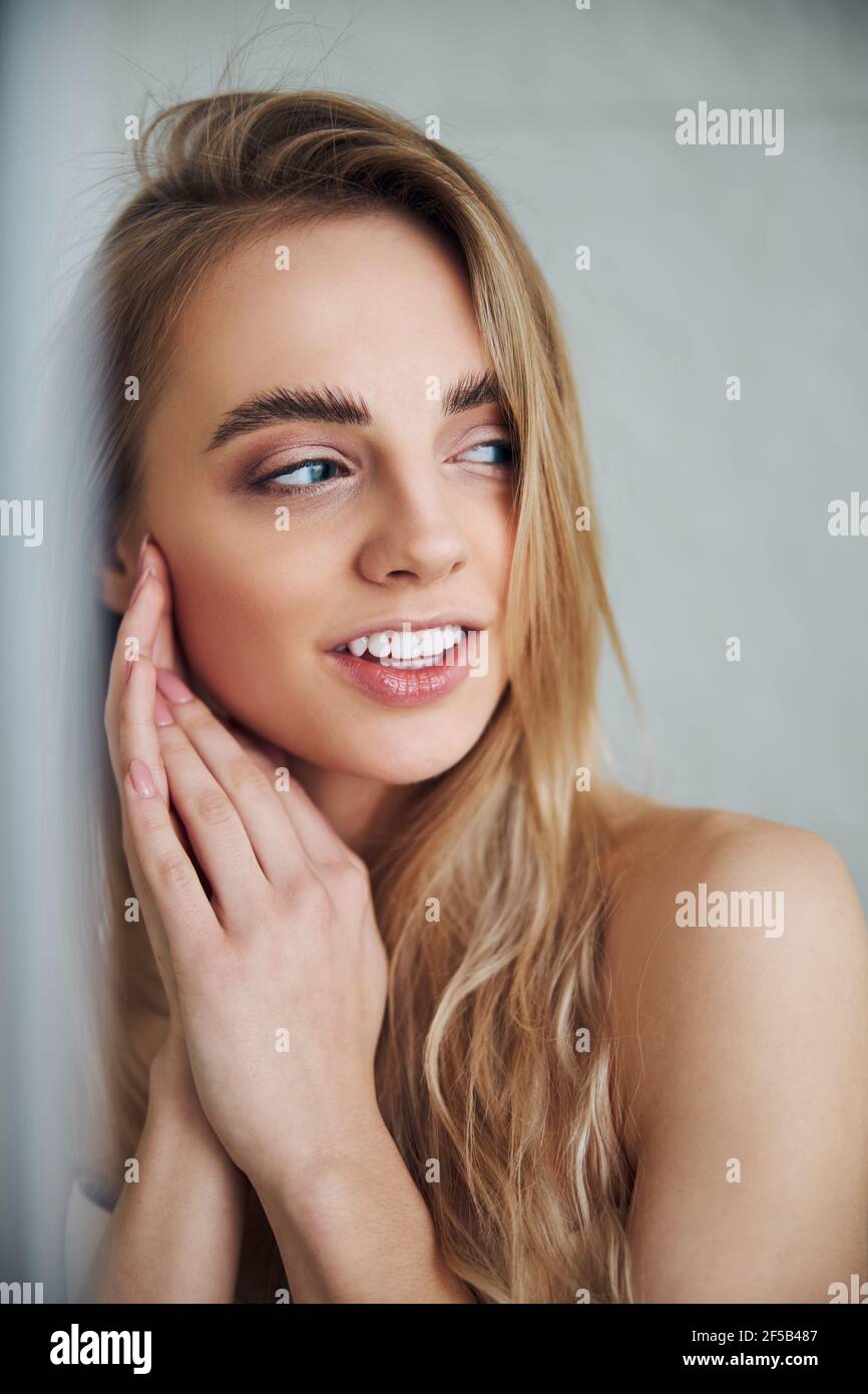 Comely long-haired woman with a pleased smile Stock Photo - Alamy