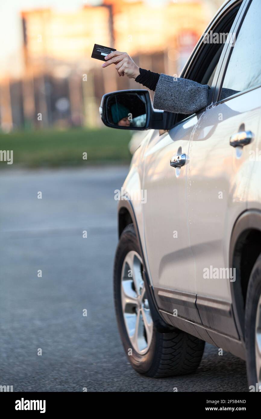 Driver takes payments by debit card without leaving own car Stock Photo ...
