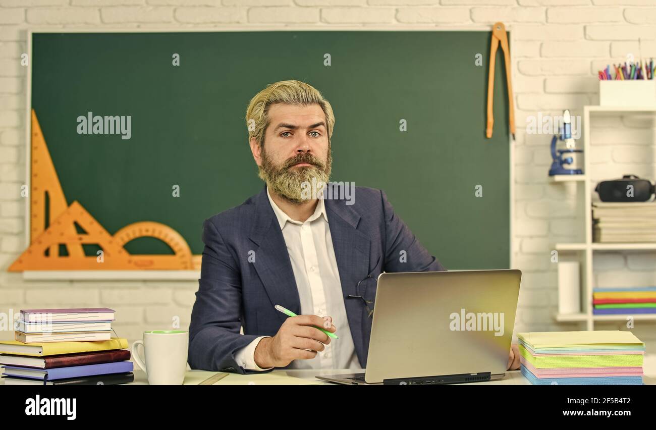 Providing useful information. Bearded man teach information at school ...