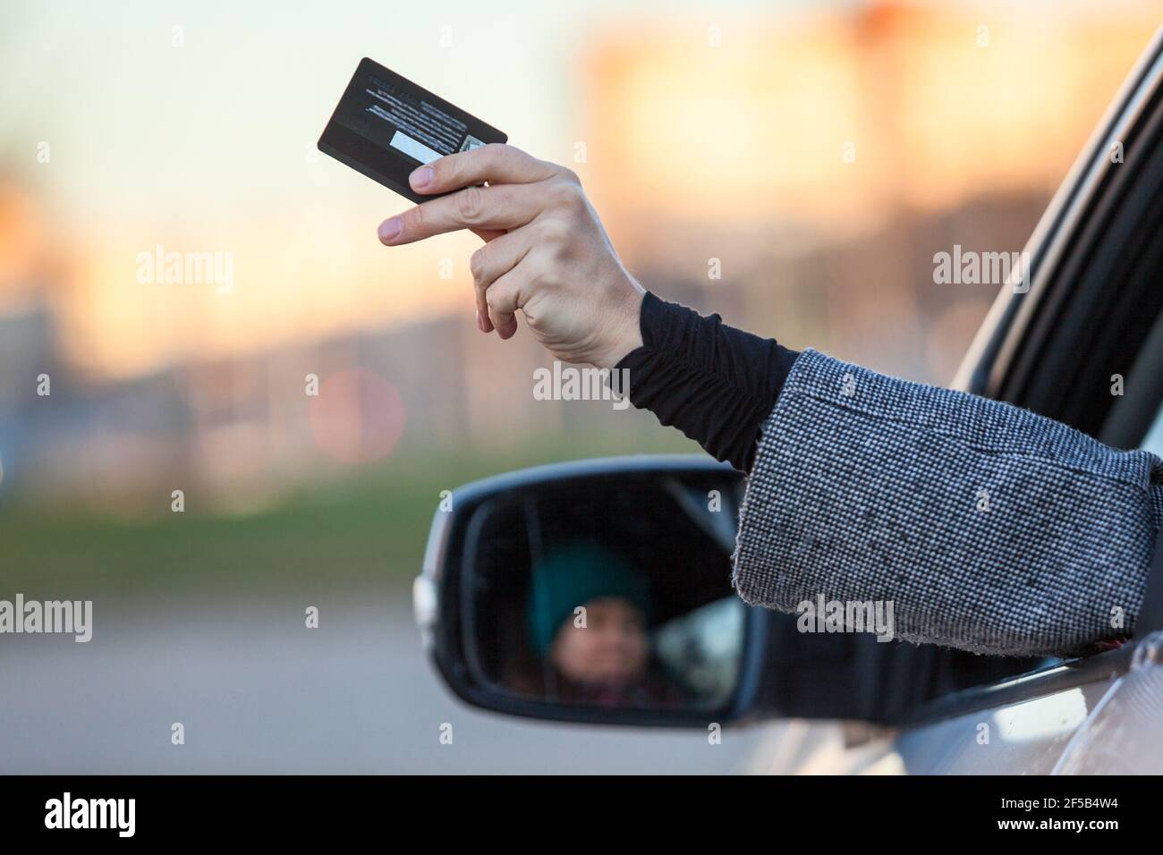 Woman a driver giving her credit card for cashless payment due the ...