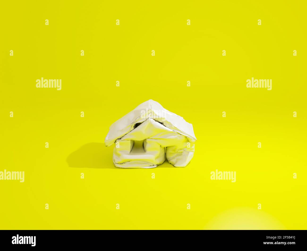 Melted or deflated house with icon shape isolated in a yellow ...