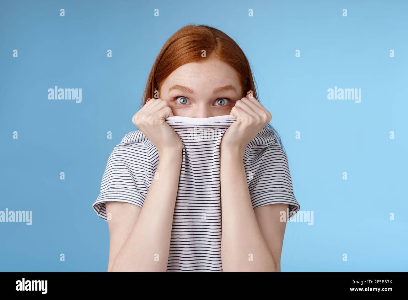 You cannot see me. Silly cute young teenage redhead girl hiding face ...