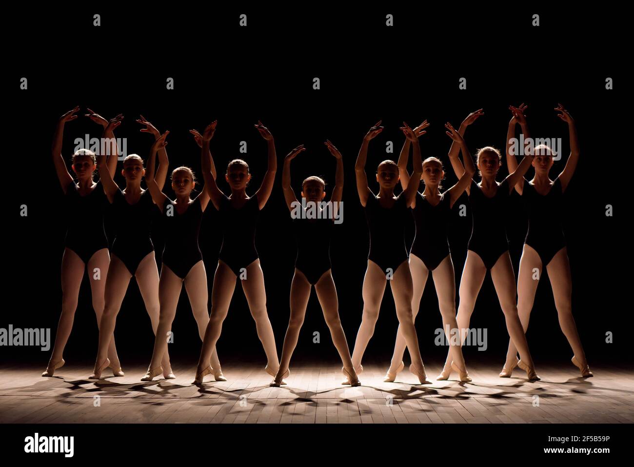 A choreographed dance of a group of graceful pretty young ballerinas ...