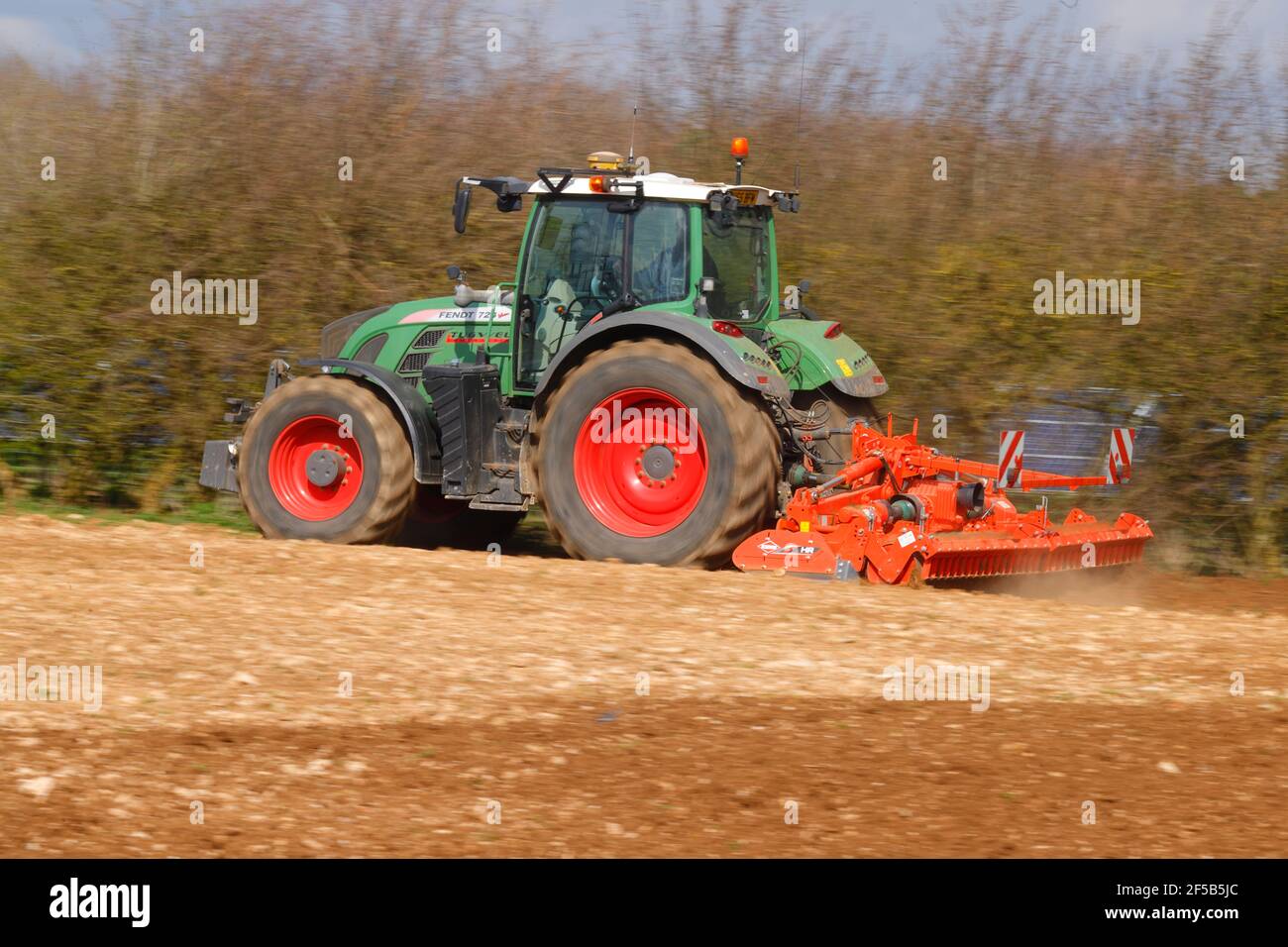A Fendt 724 Vario with stone crushing attachment on the rear Stock ...
