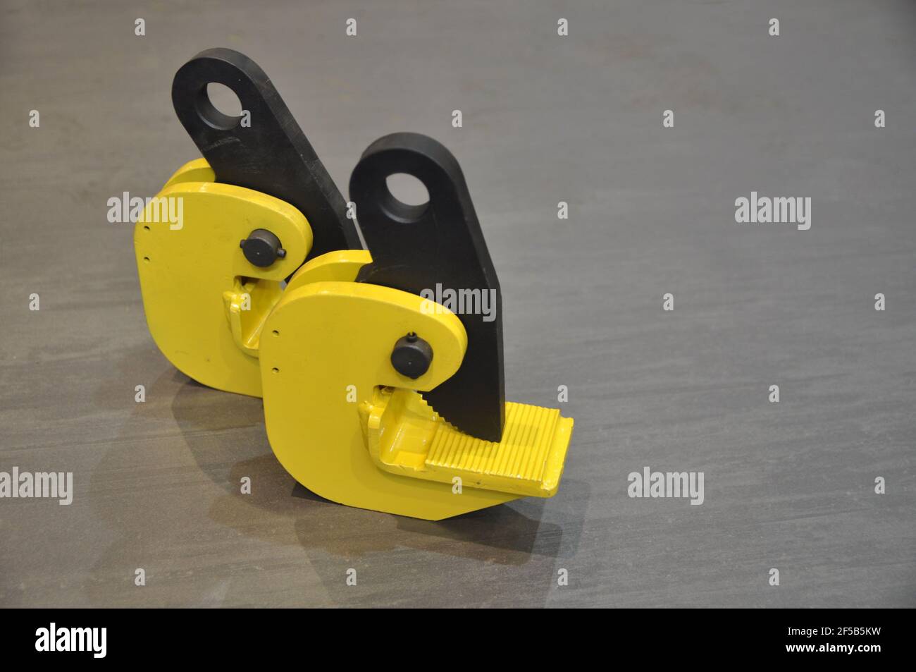 Hoisting mechanisms for loading sheet metal on a gray background. Grab ...