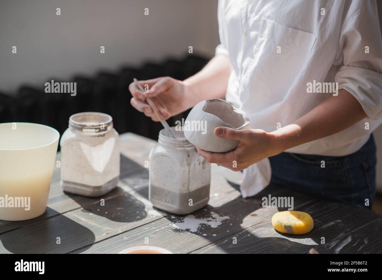 Production process of pottery. Application of glaze brush on ceramic ...