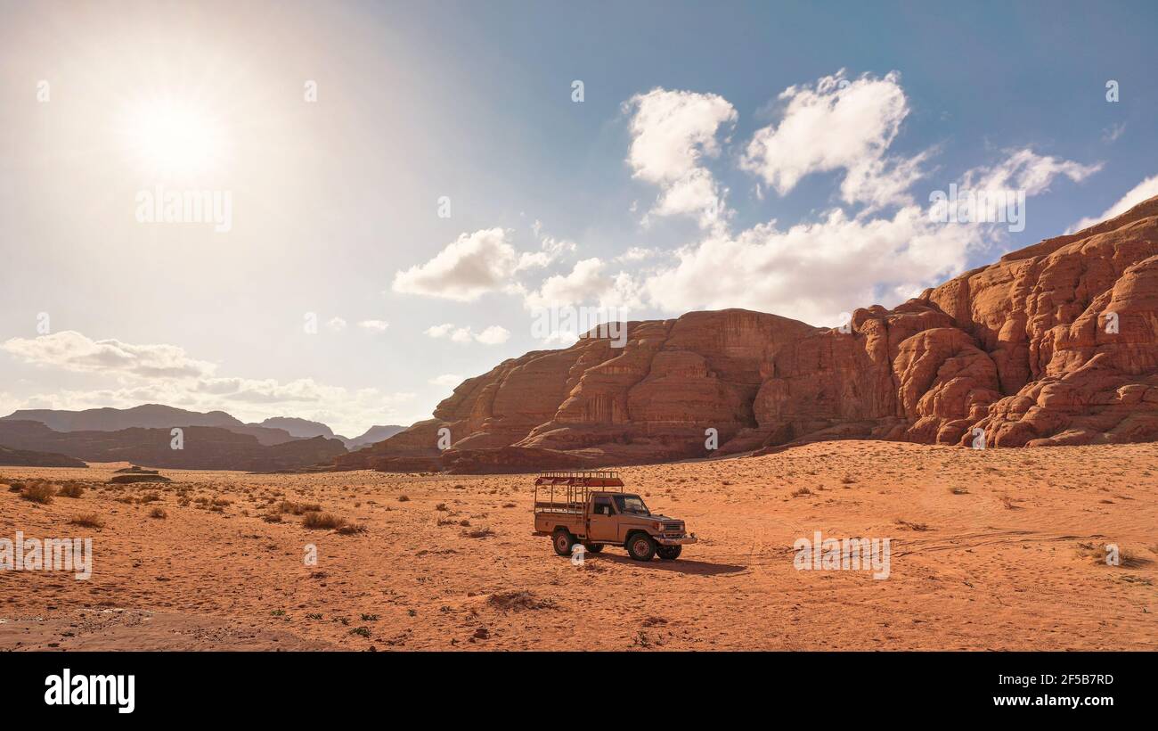 Dusty desert with rocky massif and blue sky above, off road desert ...