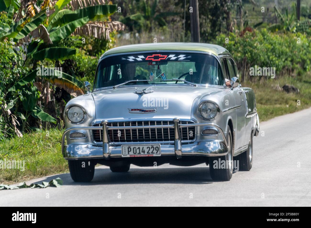Old vintage American obsolete car driving on rural road, Cuba Stock ... Old vintage American obsolete car driving on rural road, Cuba Stock ...