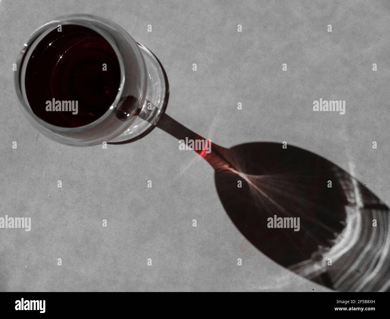 Shade on the table of a glass of red wine Stock Photo - Alamy