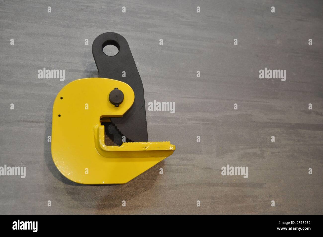 Hoisting mechanisms for loading sheet metal on a gray background. Grab ...