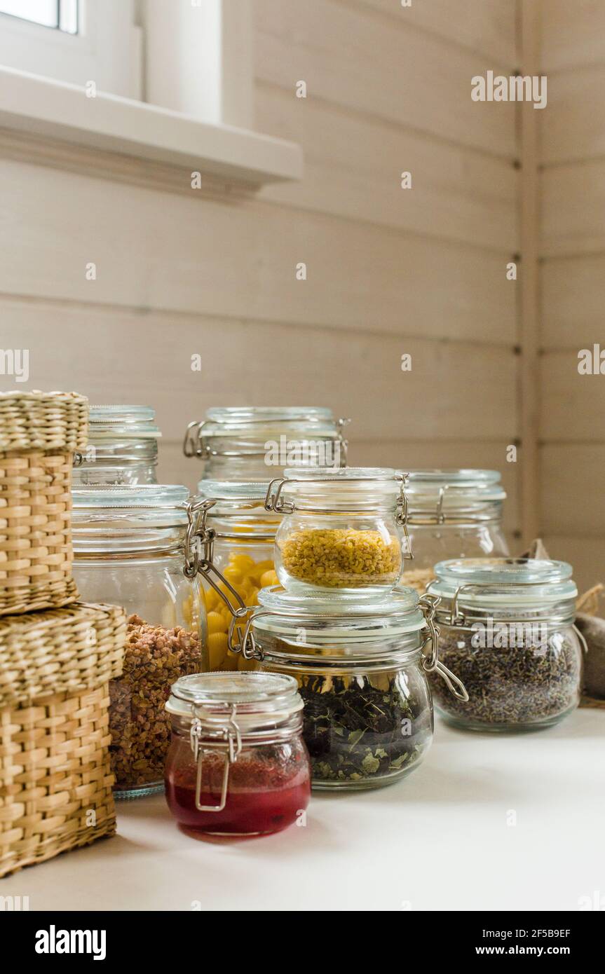 Assortment of uncooked grains, cereals and pasta in glass jars on ...