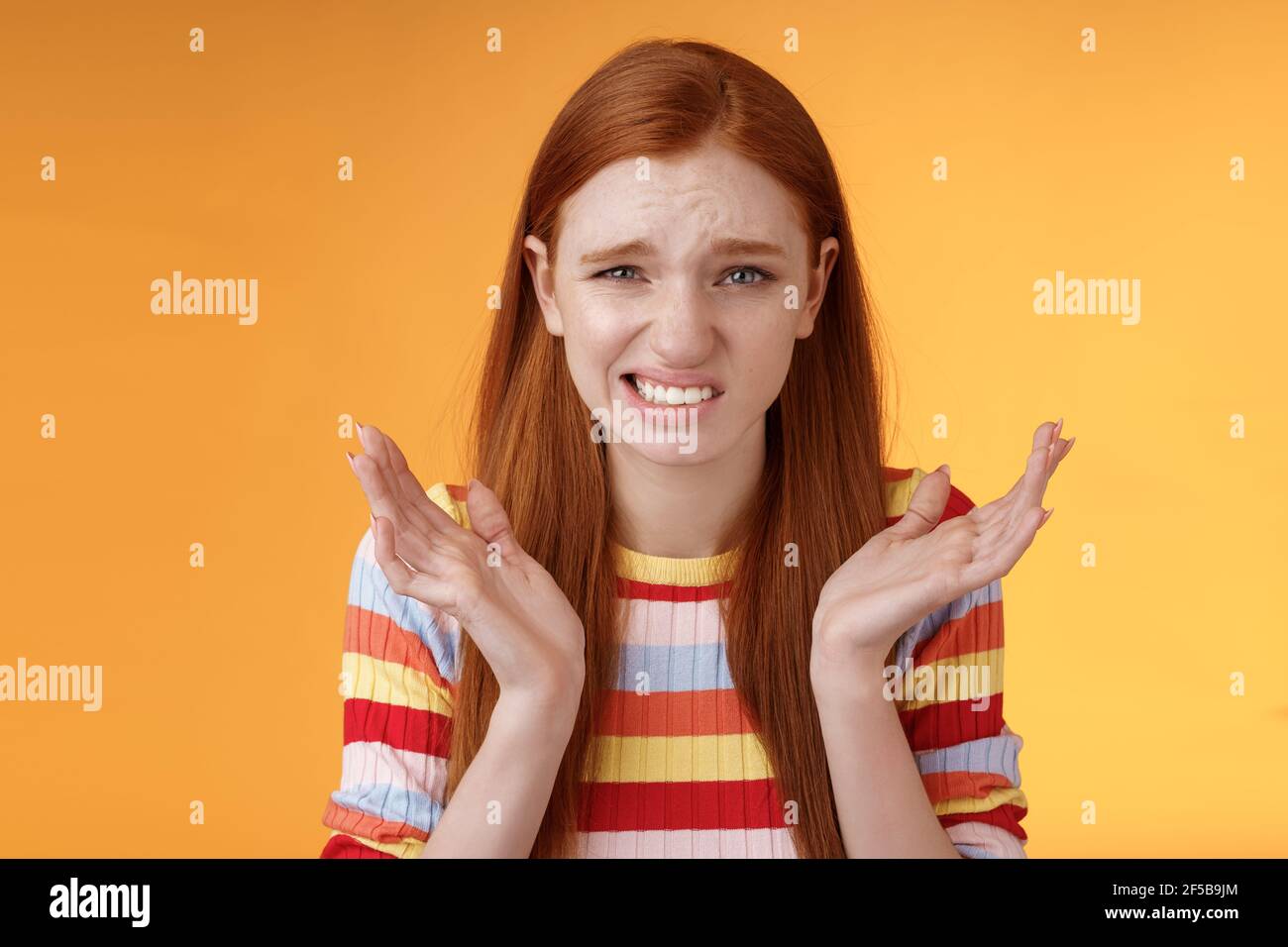 Awkward unhappy worried young redhead girl cringe feel sorry ...
