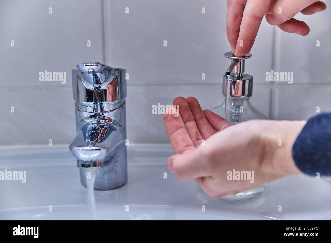 Close up of a person washing hands. Person washing their hands with ...