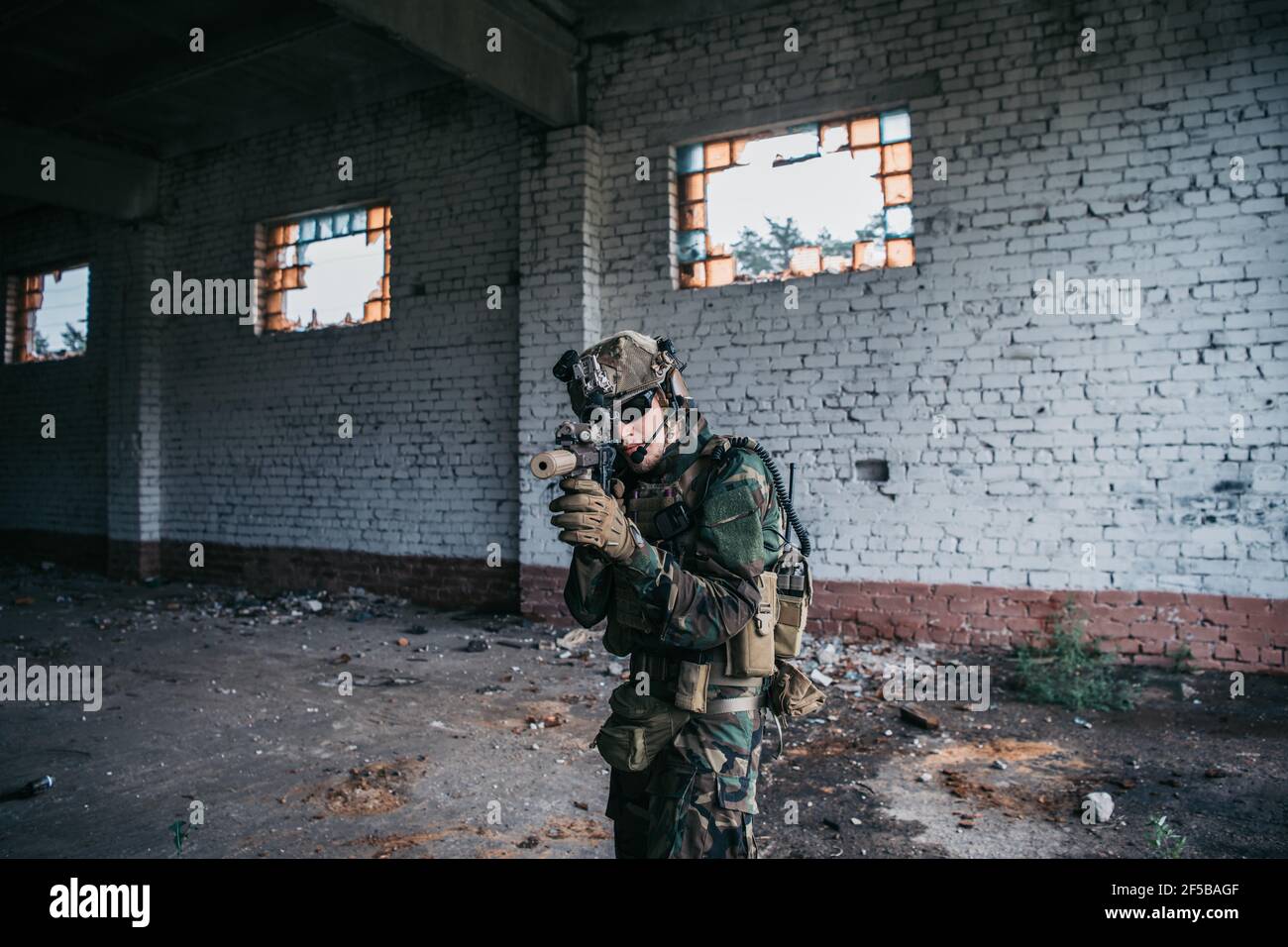 Soldier in combat. Urban combat training, soldier entering abandoned ...