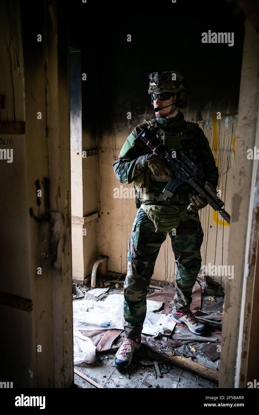 Military men with arms defending the building. Soldier stand guard ...