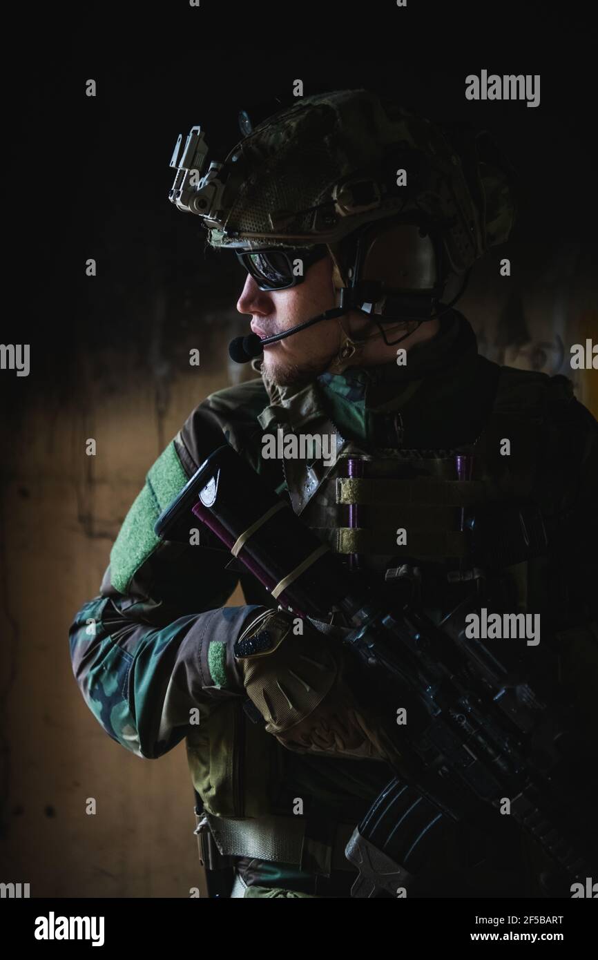 Front view close up of caucasian soldier with a rifle stand guard ...