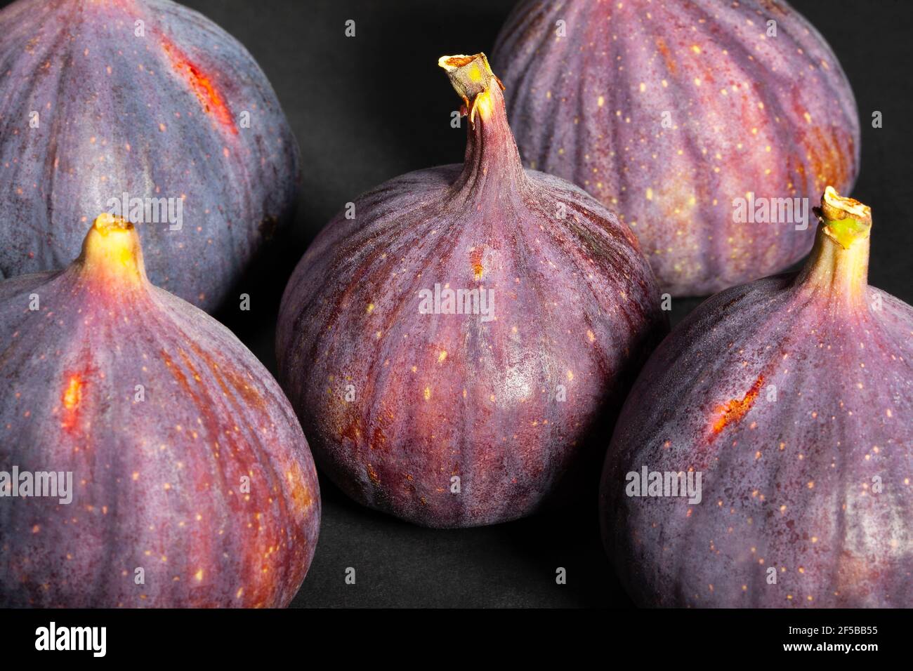 figs group on black background Stock Photo - Alamy